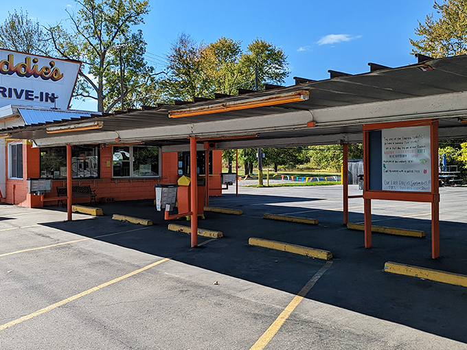 Eddie's iconic orange exterior isn't just a building—it's a time machine disguised as a drive-in, beckoning hungry travelers with its retro charm and promise of burger bliss.
