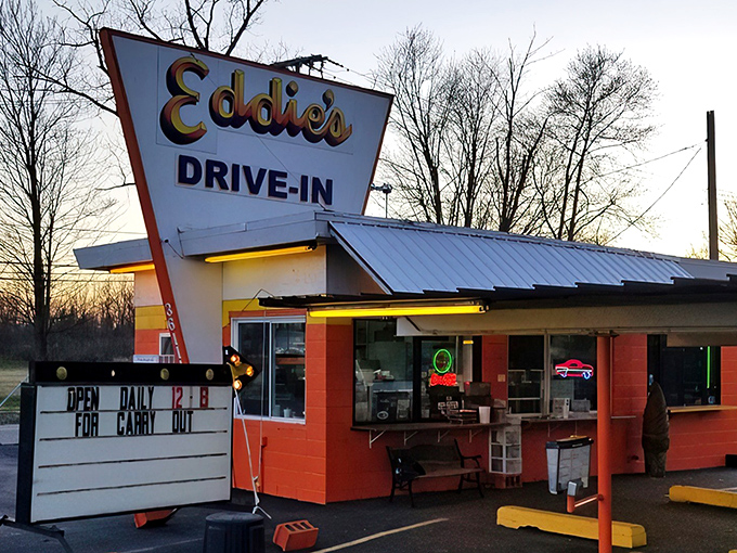 Eddie's iconic orange exterior isn't just a building—it's a time machine disguised as a drive-in, beckoning hungry travelers with its retro charm and promise of burger bliss.
