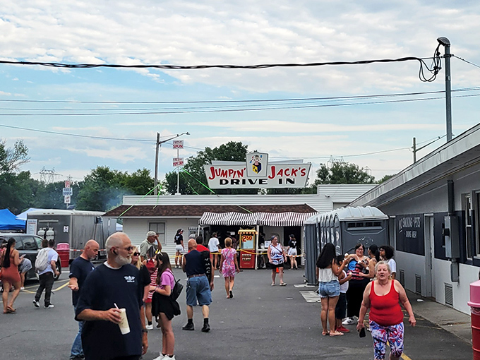 The iconic Jumpin' Jack's sign stands proudly against dramatic skies, while Old Glory waves from a fire truck ladder—a Scotia summer tradition in full swing.