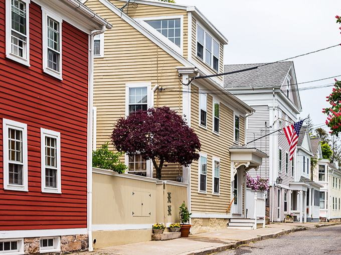 Colorful colonial homes line Stonington's streets like a New England rainbow – red, yellow, and white facades telling stories of maritime heritage.