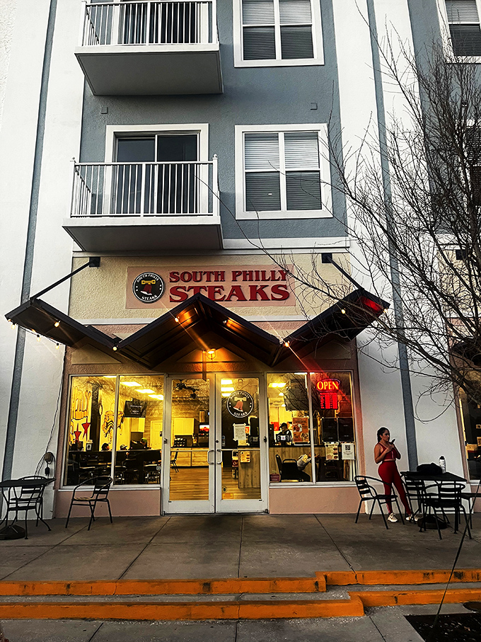 The bright red sign beckons like a lighthouse for the hungry—South Philly Steaks standing proud against Florida's sunny backdrop.