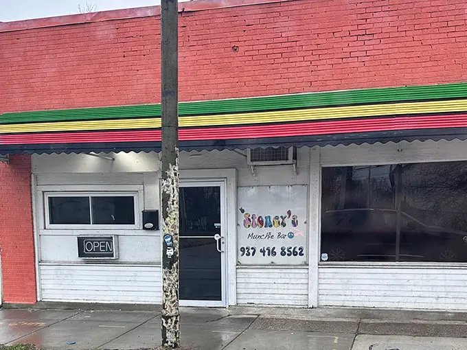 The unassuming brick exterior with its vibrant Jamaican-inspired trim is like a culinary treasure map – X marks the spot where flavor lives.