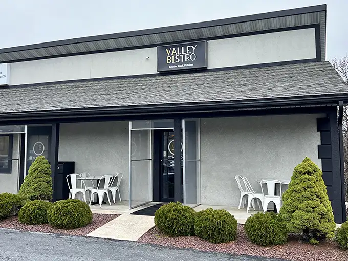 Valley Bistro's unassuming exterior hides culinary treasures within, like finding a Michelin-worthy meal in your neighbor's garage. Those manicured shrubs are just the appetizer.