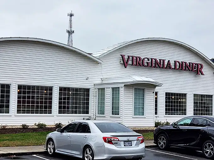 The white curved exterior of Virginia Diner stands proudly against the blue Virginia sky, a beacon of comfort food that's been calling hungry travelers home for generations.