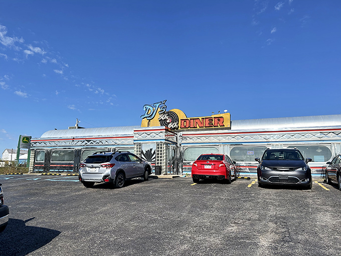 The gleaming silver exterior of DJ's isn't just a diner—it's a time machine with neon signs instead of buttons and dials.