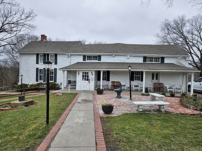 The white clapboard exterior of Stroud's Oak Ridge Manor stands like a time capsule of Americana, promising comfort food treasures within its unassuming walls.