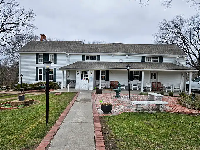 The white clapboard exterior of Stroud's Oak Ridge Manor stands like a time capsule of Americana, promising comfort food treasures within its unassuming walls.