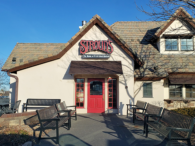 The red door at Stroud's stands like a portal to comfort food paradise, promising pan-fried delights beneath that charming pitched roof.