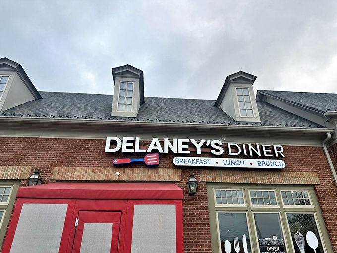 The brick exterior with those eye-catching red doors practically screams "good food inside!" Delaney's Diner stands out without trying too hard.