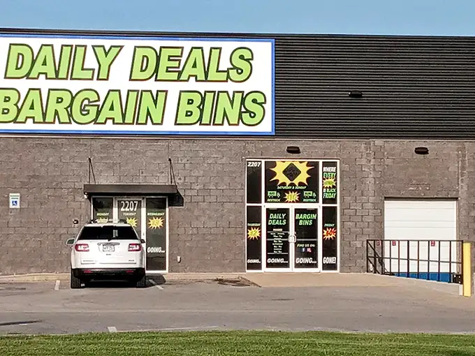 The green-and-blue beacon of bargains beckons from the gray exterior. This isn't just shopping—it's a treasure expedition with daily-changing prices.