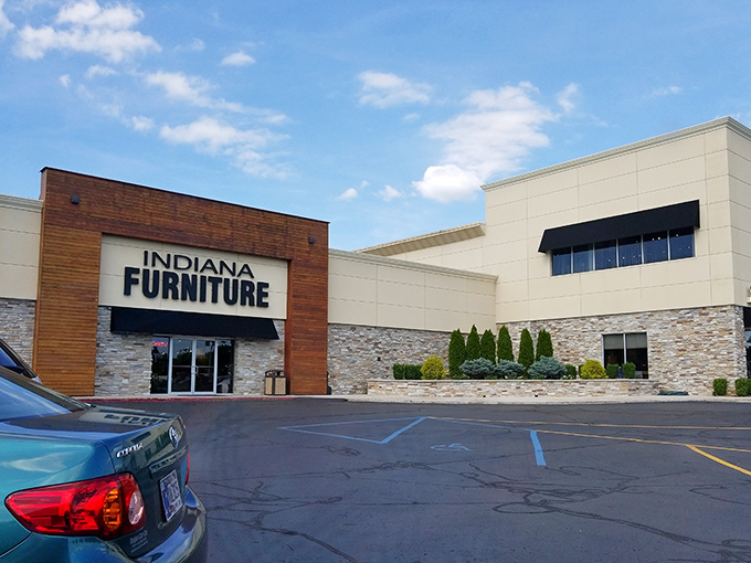 The modern exterior blends warm wood paneling with stone accents, creating a façade that says "Yes, I'm a furniture store, but I've got style."