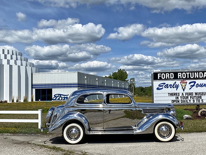 A gleaming 1936 Ford sedan poses like a silver screen starlet against the museum's distinctive white architecture. Automotive time travel at its finest.