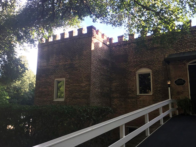 The castle's brick exterior with crenellated walls isn't just for show—it's your first clue that dinner tonight will be anything but ordinary.