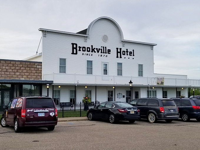 The iconic white facade of Brookville Hotel stands proudly against the Kansas sky, a beacon for fried chicken pilgrims from across the Midwest.