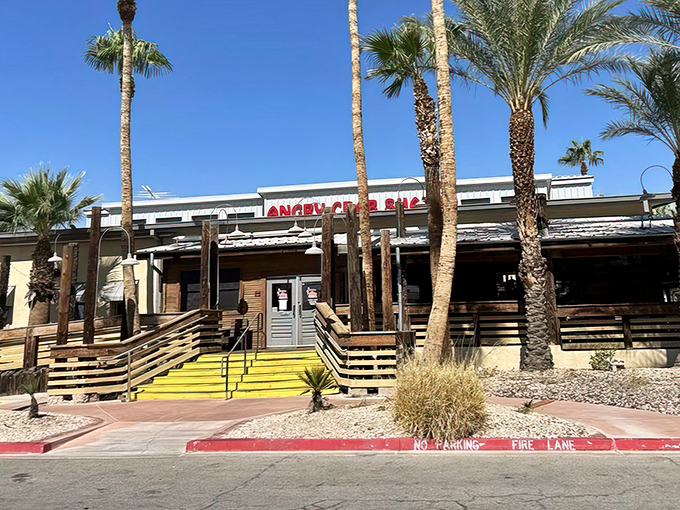 Palm trees and wooden ramps welcome you to seafood paradise—where the desert meets the ocean at Angry Crab Shack's inviting Henderson location.