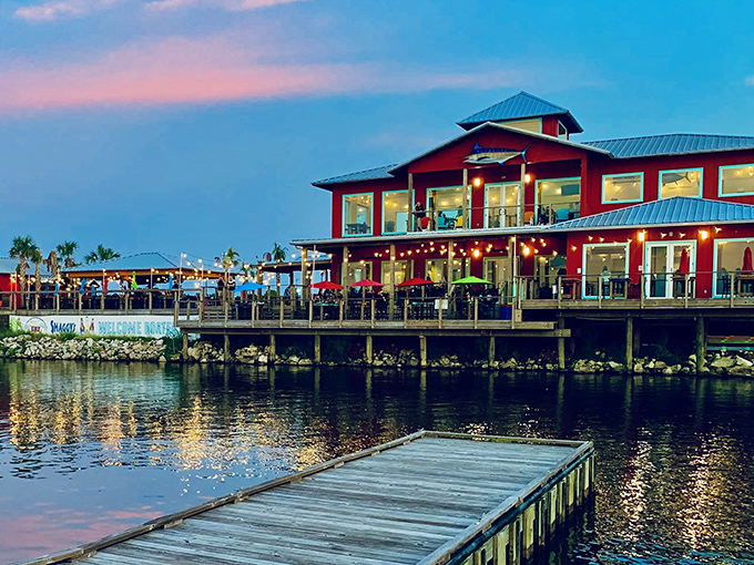 The vibrant red exterior of Shaggy's stands out like a cheerful beacon, promising coastal delights with palm trees that whisper, "Vacation starts here."