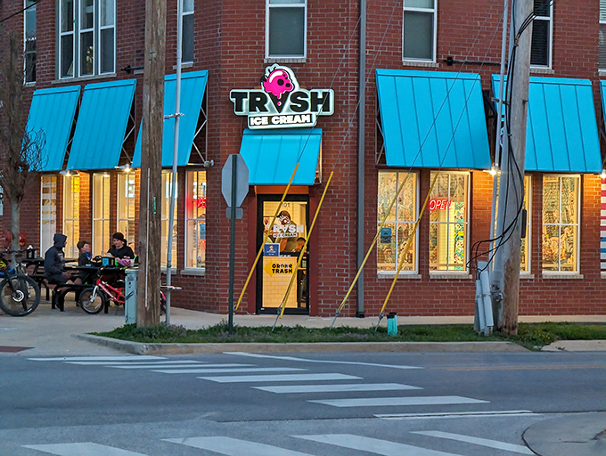 TRVSH's brick corner location in downtown Bentonville beckons with its distinctive metal awnings and inviting picnic tables—architectural foreplay for the flavor explosion waiting inside.
