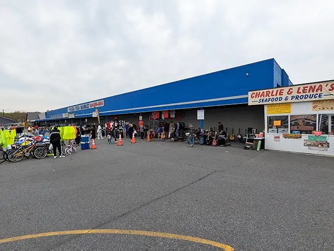 The blue facade of Plaza Flea Market beckons like a retail Narnia—where your wallet enters full and exits empty, but your heart does the opposite.