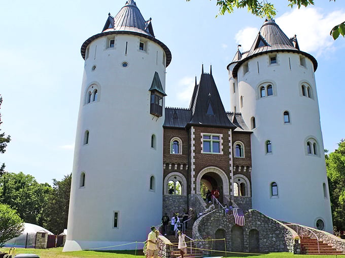 The majestic exterior of Castle Gwynn stands proudly against the Tennessee sky, its white towers a startling medieval vision in the Southern landscape.