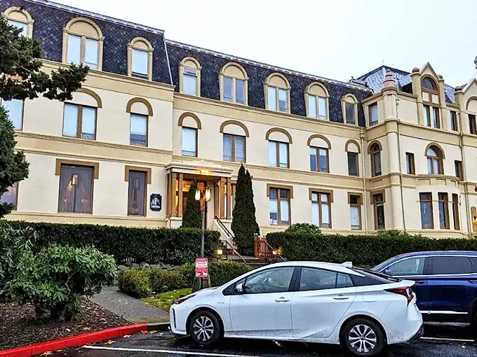 The cream-colored façade of Manresa Castle stands proudly against the Washington sky, like European royalty who decided the Pacific Northwest needed more turrets.
