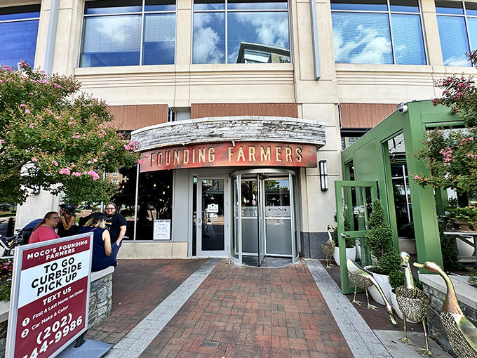 The unassuming entrance to flavor paradise. Founding Farmers' modest exterior in Potomac gives zero hints about the culinary fireworks waiting inside.