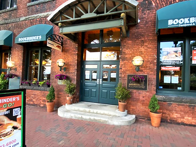 The historic brick façade of Bookbinder's welcomes you with teal awnings and warm globe lights—Richmond's culinary time machine disguised as a restaurant. 