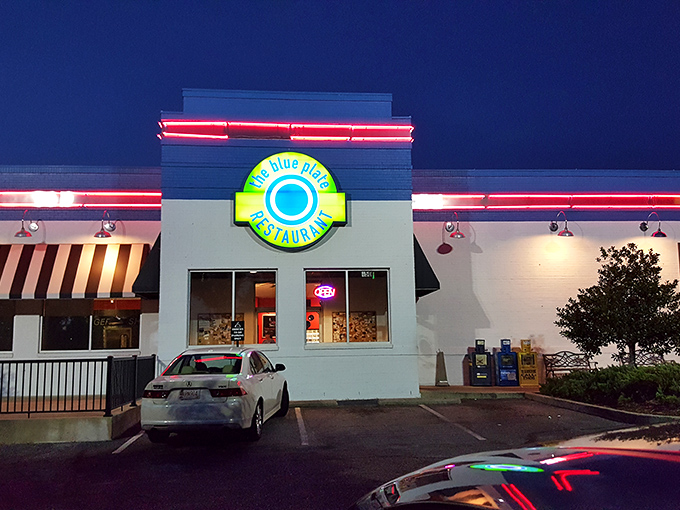 The blue and white exterior of The Blue Plate stands out like a beacon of hope for hungry travelers. This unassuming building holds culinary treasures within.