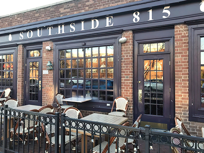 The inviting brick exterior of Southside 815 with its navy blue awning and charming patio seating beckons hungry travelers like a Southern lighthouse.
