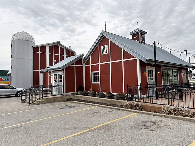 The red barn-like structure with its silo isn't just architectural flair—it's a beacon calling hungry travelers home to barbecue paradise.
