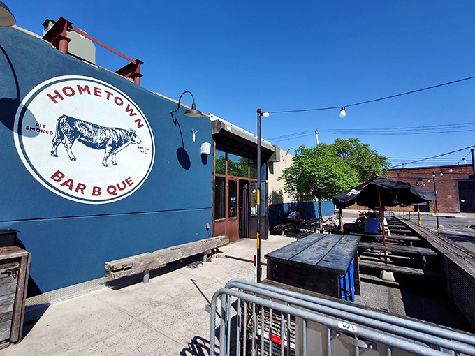 The blue exterior with its vintage cow logo isn't just a restaurant front—it's a beacon of smoke-scented hope for barbecue pilgrims seeking meaty salvation.