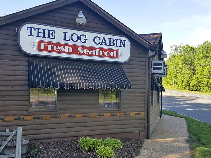 The rustic exterior of The Log Cabin isn't just charming—it's a promise that what awaits inside is authentic, unpretentious, and deliciously memorable.