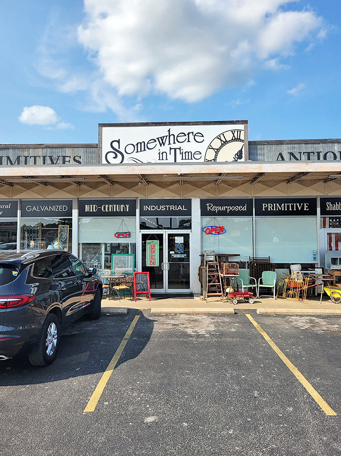 The unassuming storefront of Somewhere In Time beckons with promises of "PRIMITIVES" and "ANTIQUES" – a time portal disguised as a strip mall tenant.