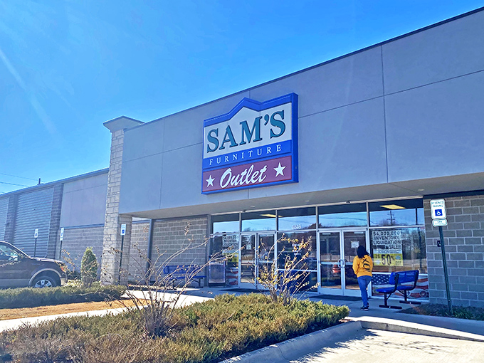 The iconic red entrance of Sam's Furniture stands out like a Broadway marquee, complete with a patriotic inflatable tube man welcoming shoppers to the furniture wonderland.