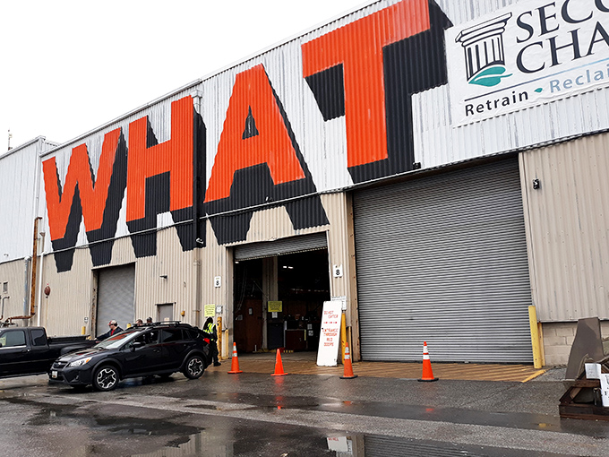 The warehouse with "WHAT" emblazoned across it isn't asking a question—it's making a statement about possibility and transformation.