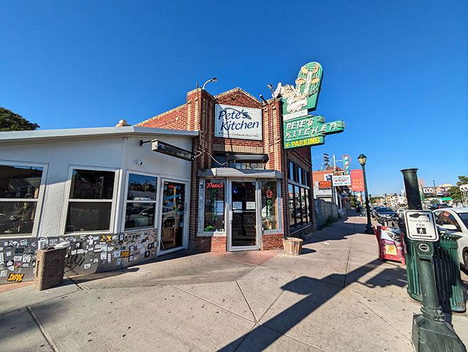 The neon glow of Pete's Kitchen at dusk isn't just a sign—it's a beacon of hope for hungry souls wandering Colfax Avenue. 