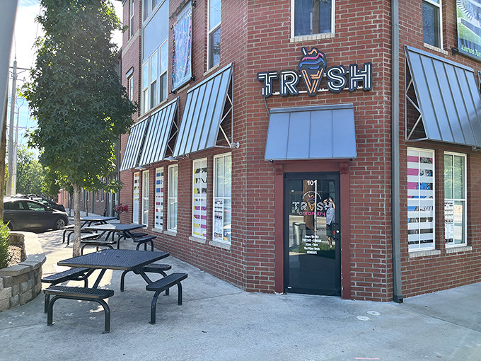 TRVSH's brick corner location in downtown Bentonville beckons with its distinctive metal awnings and inviting picnic tables—architectural foreplay for the flavor explosion waiting inside.