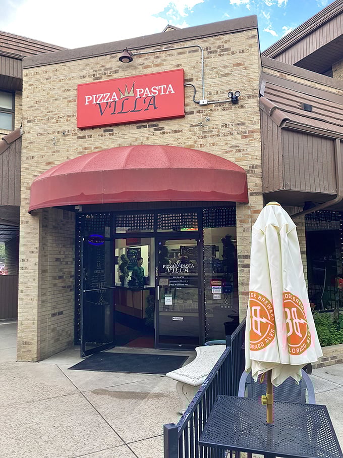 The welcoming storefront of Pizza Pasta Villa announces itself without fanfare—just a simple red sign promising honest Italian comfort that delivers every time.