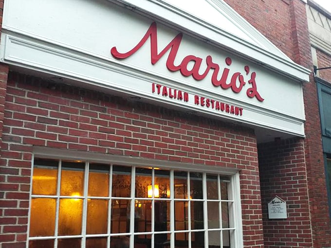 The iconic red script of Mario's against classic brick – like a neon welcome sign for your stomach that's been guiding hungry Lexingtonians for generations.