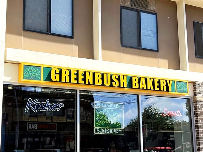 The iconic green and yellow storefront of Greenbush Bakery stands as a beacon of hope for donut lovers across Madison. That neon "Kosher" sign promises authentic goodness inside.