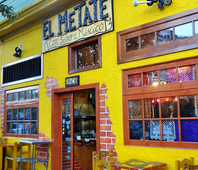 That sunshine-yellow exterior isn't just a building—it's a mood-altering device that says "happiness served daily." The colorful chairs outside are just a preview of the fiesta within.