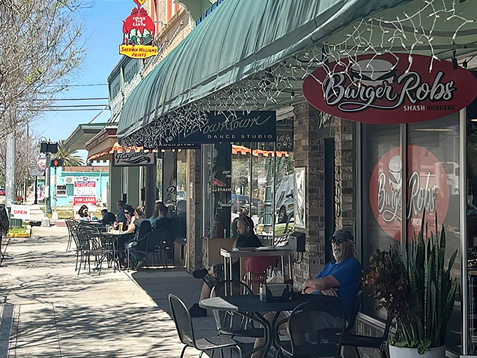 The unassuming storefront of BurgerRobs in Titusville beckons with its red signage and outdoor seating—a burger sanctuary hiding in plain sight.