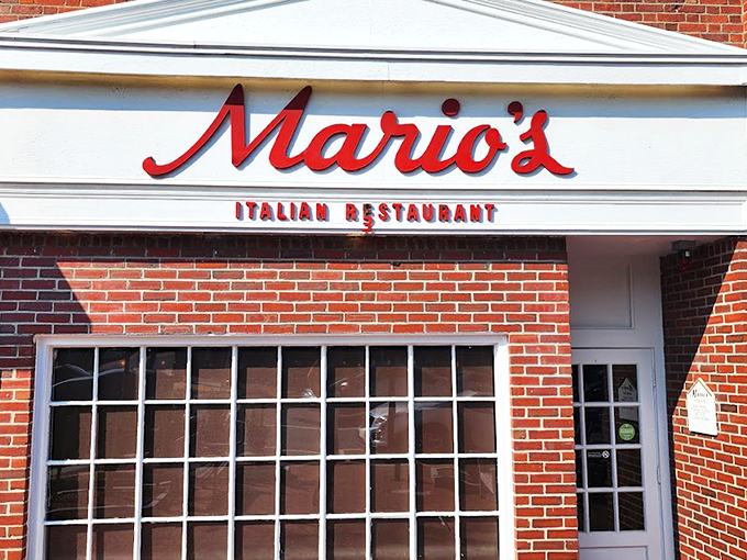 The iconic red script of Mario's against classic brick – like a neon welcome sign for your stomach that's been guiding hungry Lexingtonians for generations.