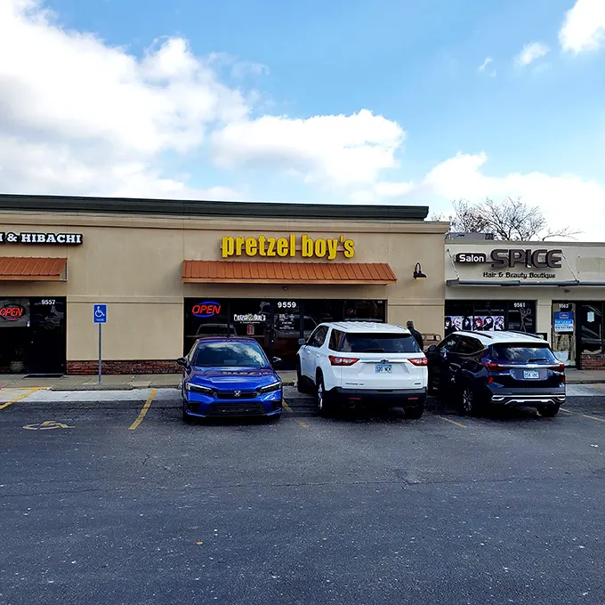 The bright yellow sign of Pretzel Boy's beckons like a carb-loving lighthouse, promising twisted delights within this Overland Park storefront.