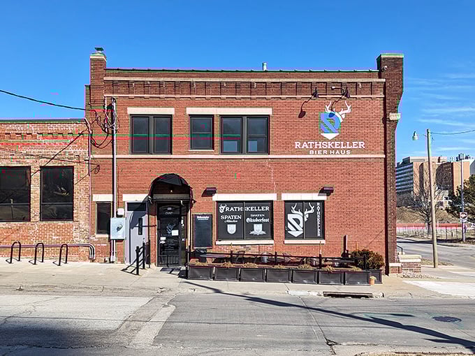The brick exterior of Rathskeller Bier Haus stands proudly in Omaha, complete with Bavarian blue and white flags fluttering in the Nebraska breeze.