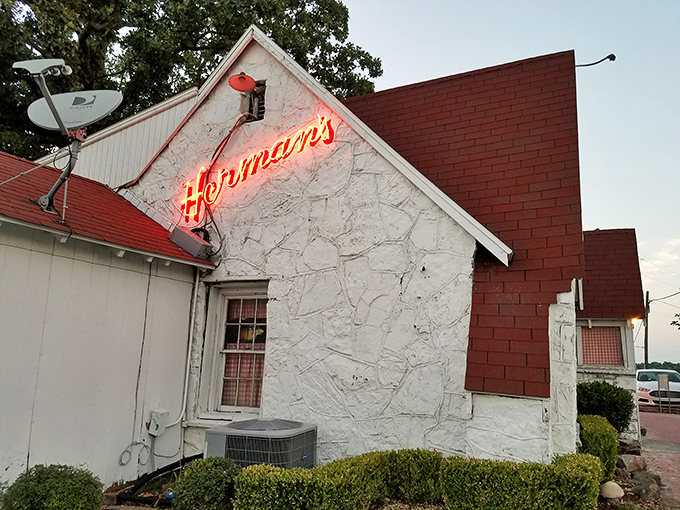 The unassuming white cottage exterior of Herman's Ribhouse is Arkansas's version of a culinary TARDIS – modest outside, magnificent within.