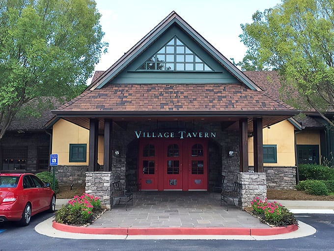 Those iconic red doors might as well have a sign that reads "Prime Rib Pilgrimage Starts Here." The stone façade and peaked roof promise comfort before you even step inside.