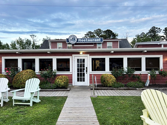 The unassuming pink exterior of Coinjock Marina Restaurant—proof that culinary treasures often hide in plain sight along North Carolina's waterways.