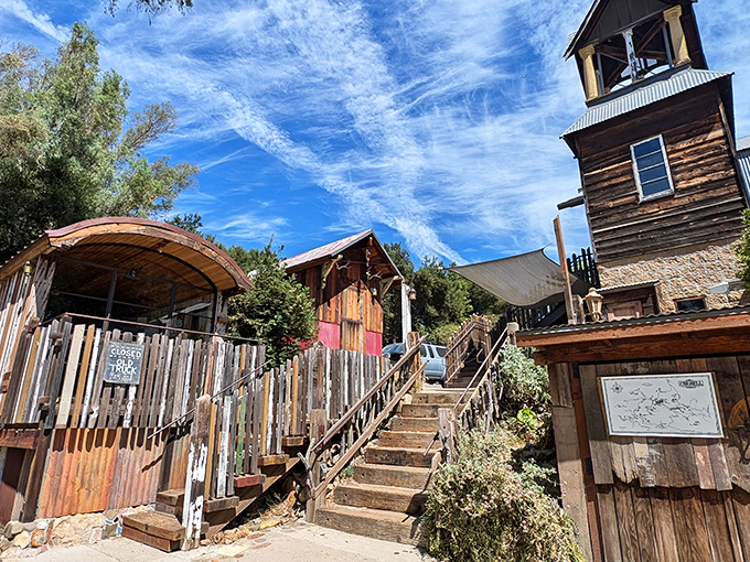 The Old Place stands proudly against the California sky, its weathered wooden exterior and bell tower looking like they've been waiting for John Wayne to ride up.