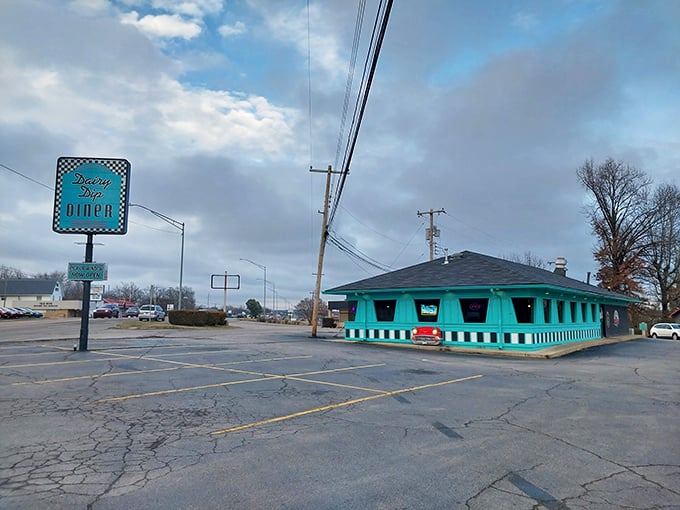 The turquoise time capsule beckons from the roadside, complete with classic car grille built right into the façade. Mid-century perfection awaits inside.
