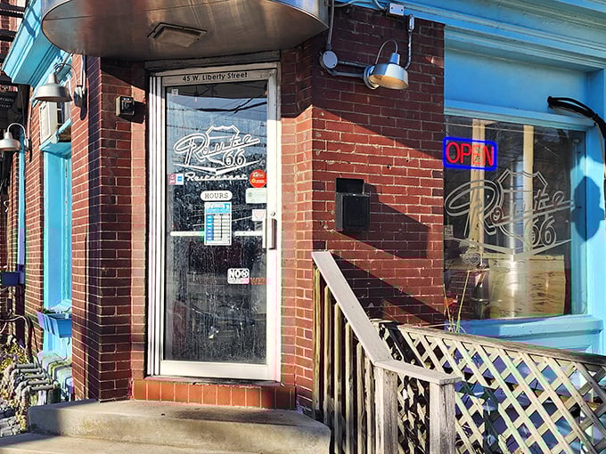The unassuming brick entrance with its vibrant blue trim promises more than meets the eye—a perfect roadside discovery hiding in plain sight on Liberty Street.